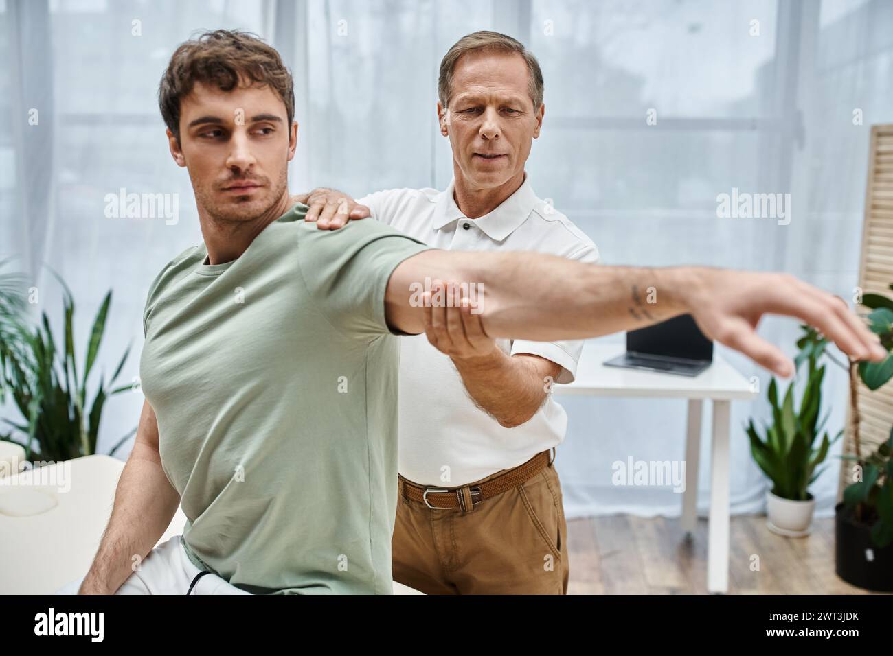 attractive merry doctor in uniform helping his good looking patient to ...