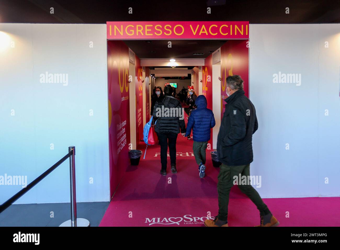 A woman with her son as they enter in the vaccination rooms, on the ...