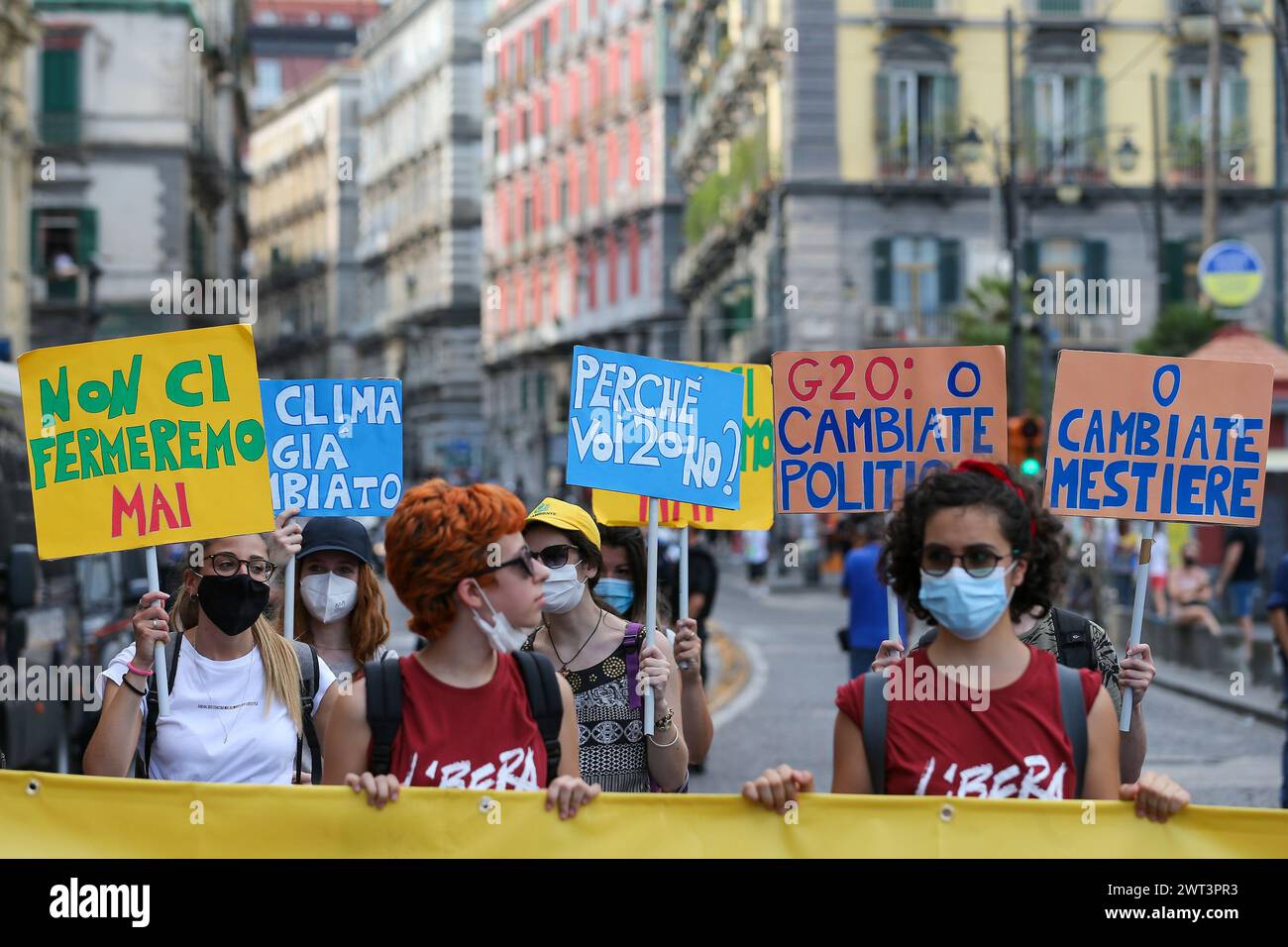 Protesters (with masks to protect against Covid-19), with signs and ...