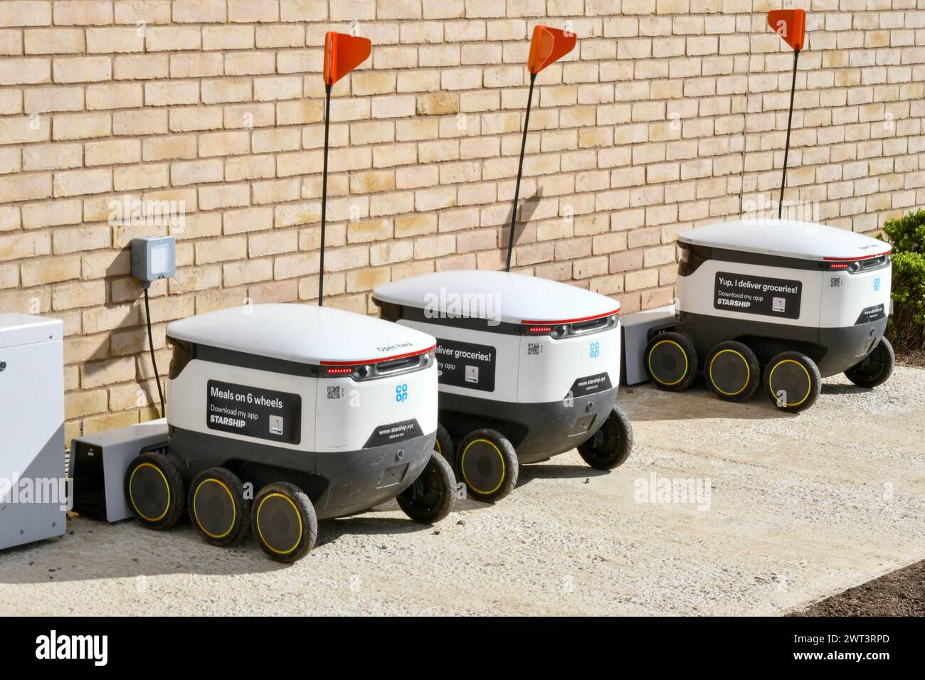Delivery robots at charging point Stock Photo - Alamy