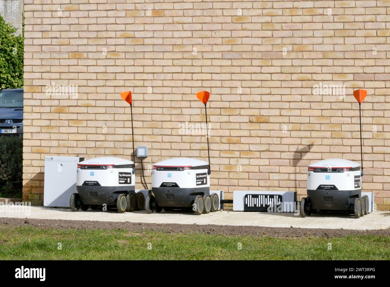 Delivery robots at charging point Stock Photo - Alamy