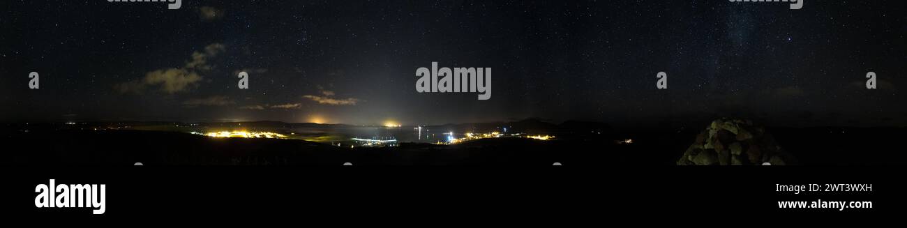 Stromness harbour and town night time panorama with stars and milky way ...