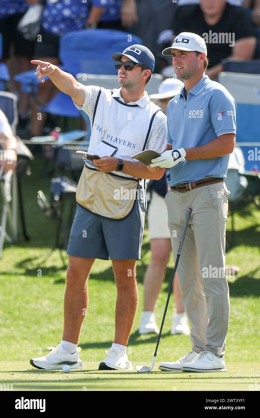 March 15, 2024: Austin Eckroat confers with his caddie on the 17th hole ...