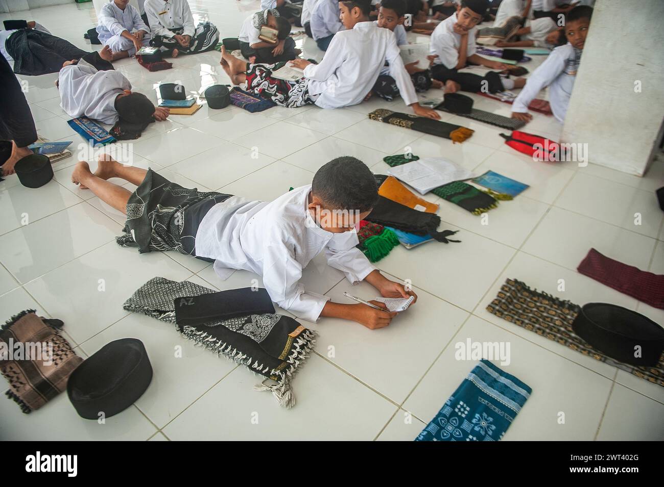 A Muslim student is seen to keep learning before attending the first ...