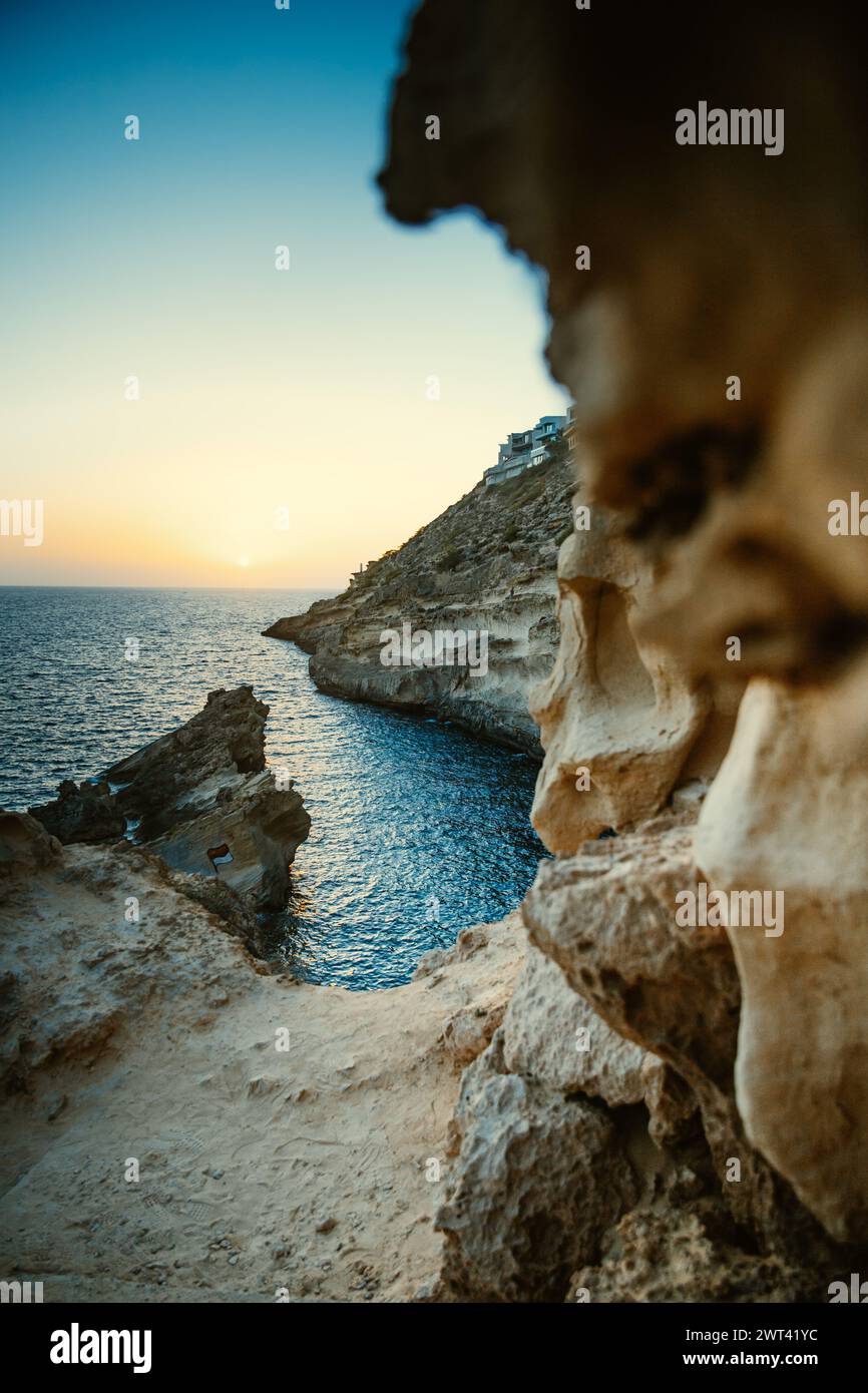 A large rock at ocean coast during sunset Stock Photo - Alamy