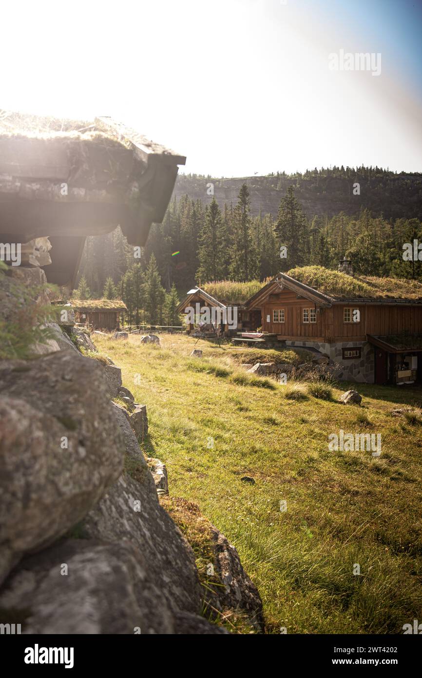 A vast mountain landscape with distant houses, trees, and grassc Stock ...