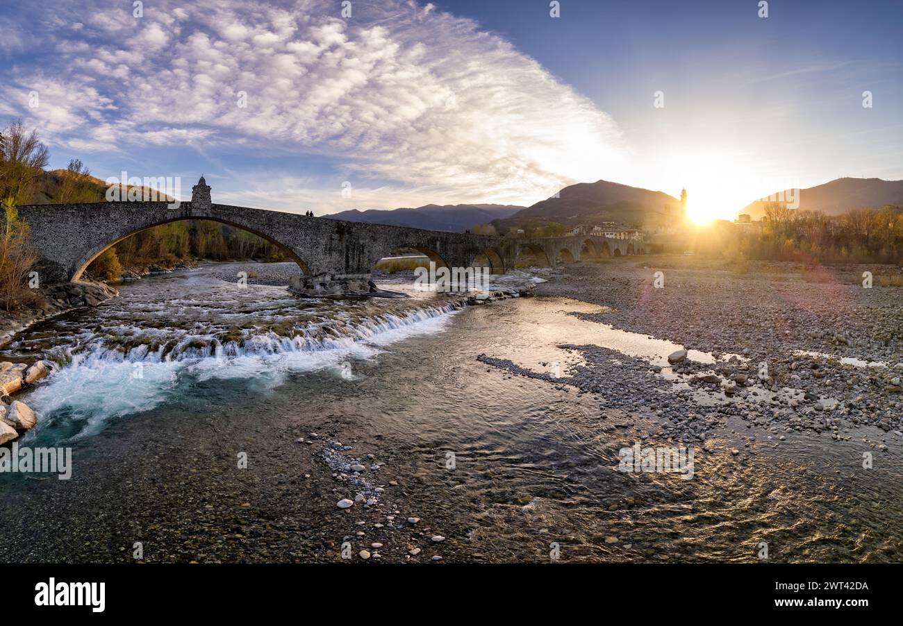 Aerial view of Bobbio town and Gobbo Bridge of Devil at sunset. Trebbia ...