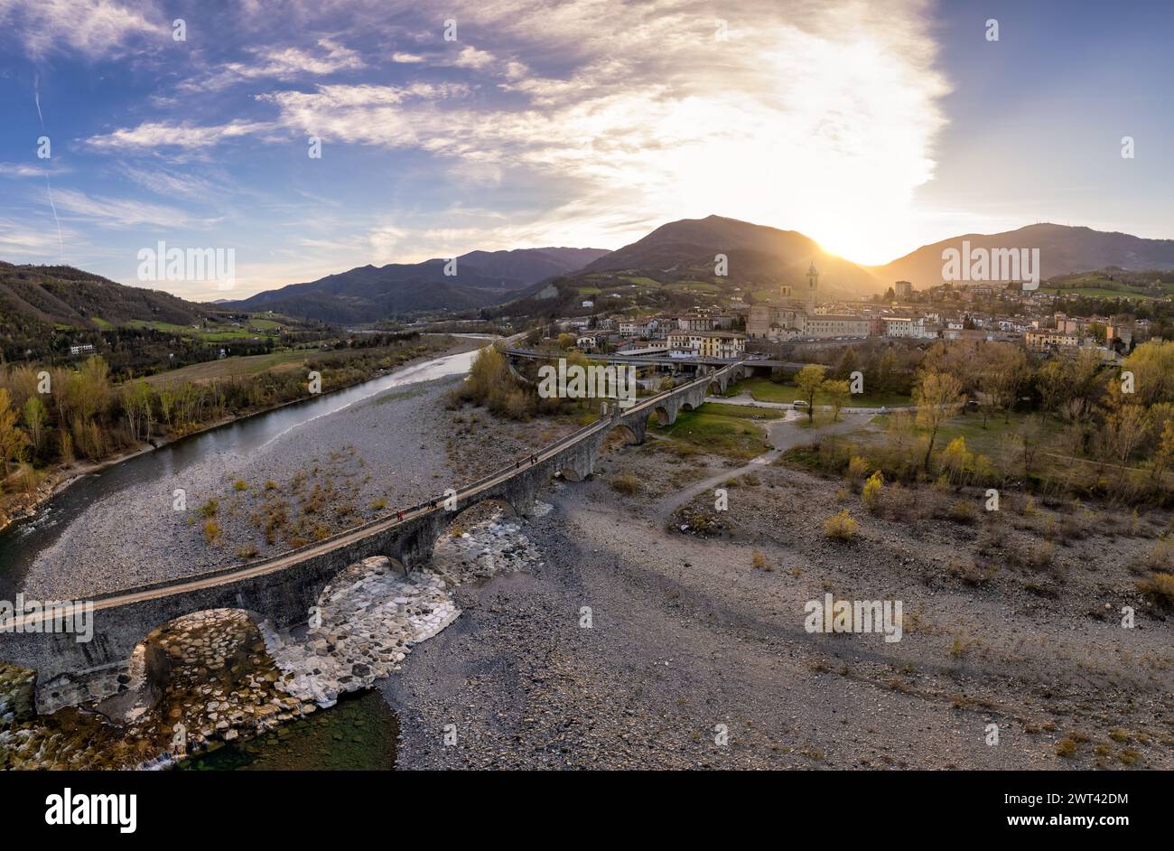 Aerial view of Bobbio town and Gobbo Bridge of Devil at sunset. Trebbia ...