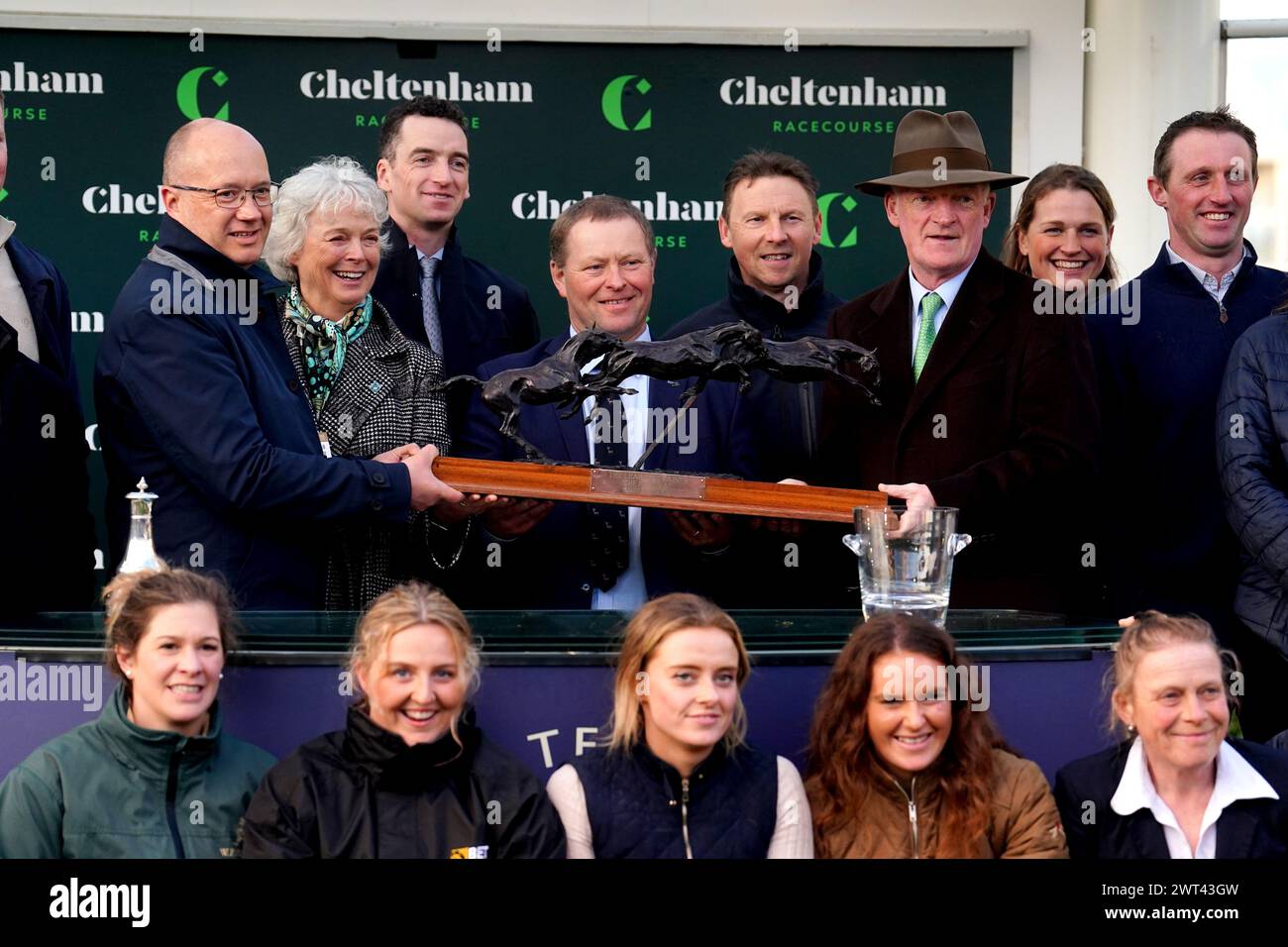 Willie Mullins poses for a photo with his connections after winning the ...