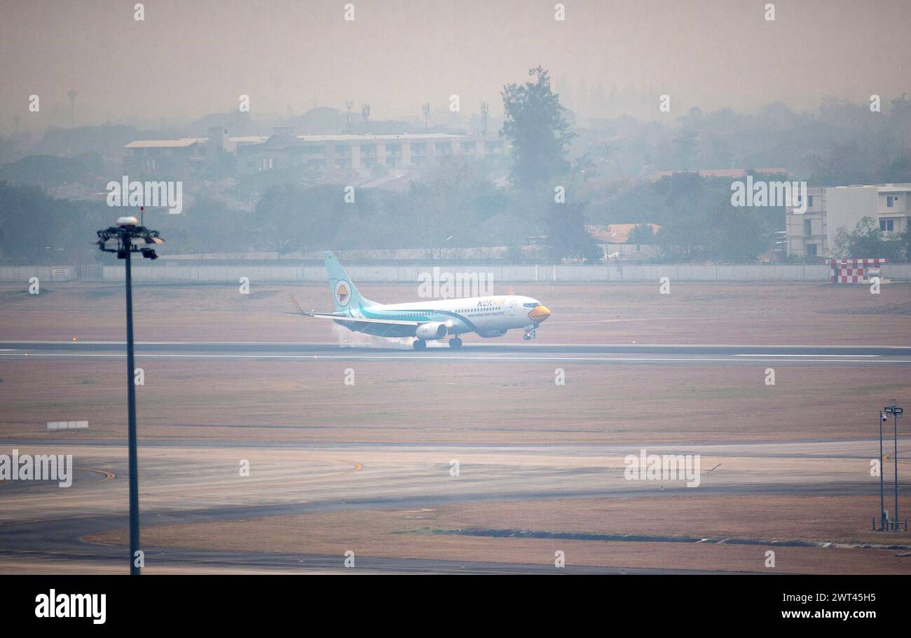 A Nok Air aircraft lands amid smog from heavy concentrations of fine ...