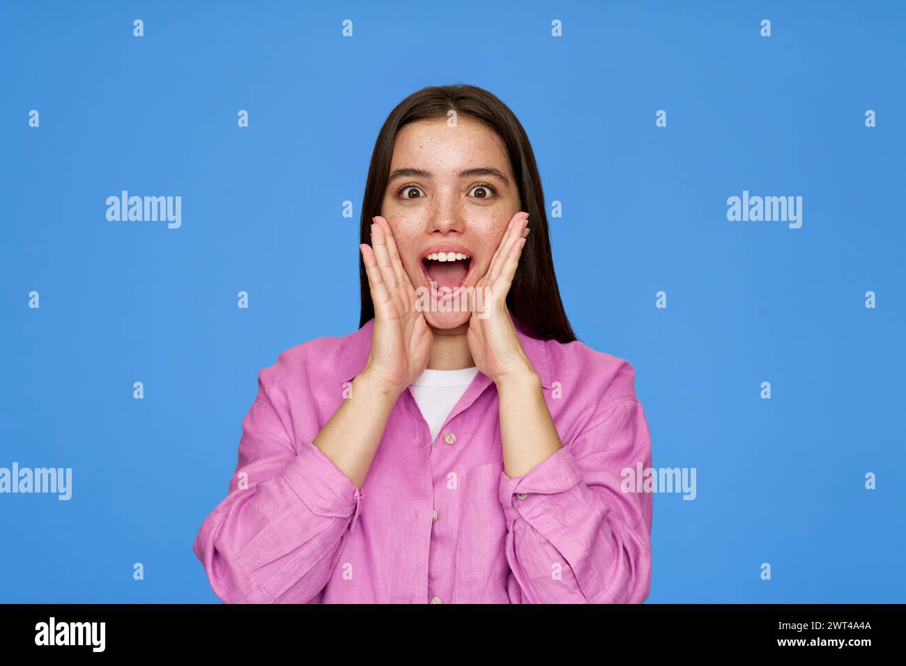 Excited Latin teenage girl with wow face expression feeling surprise on ...