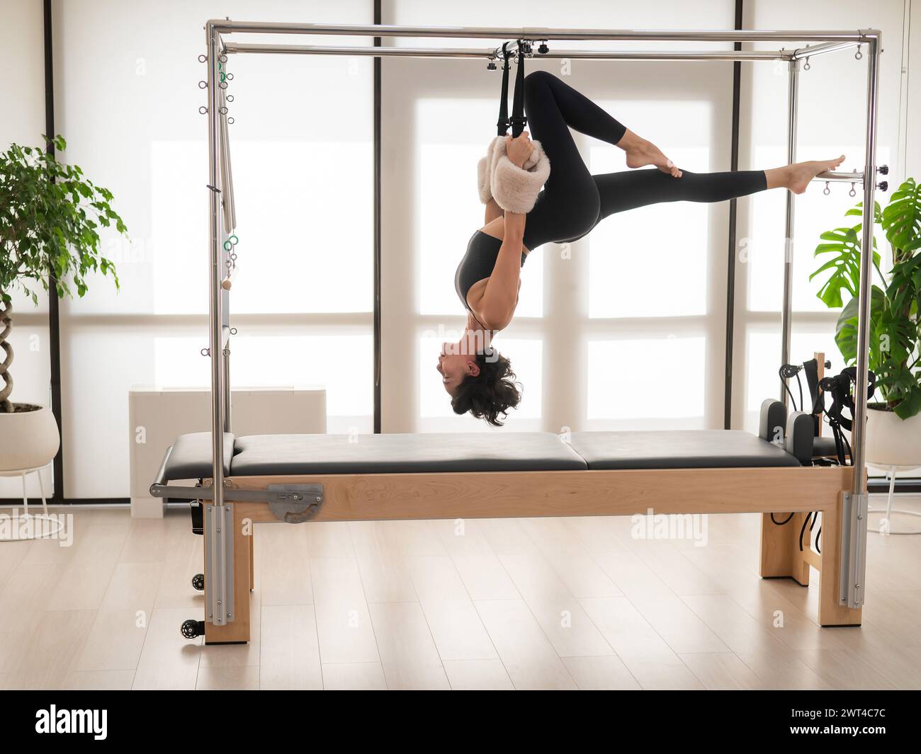 Asian woman doing aerial exercise on reformer machine Stock Photo - Alamy