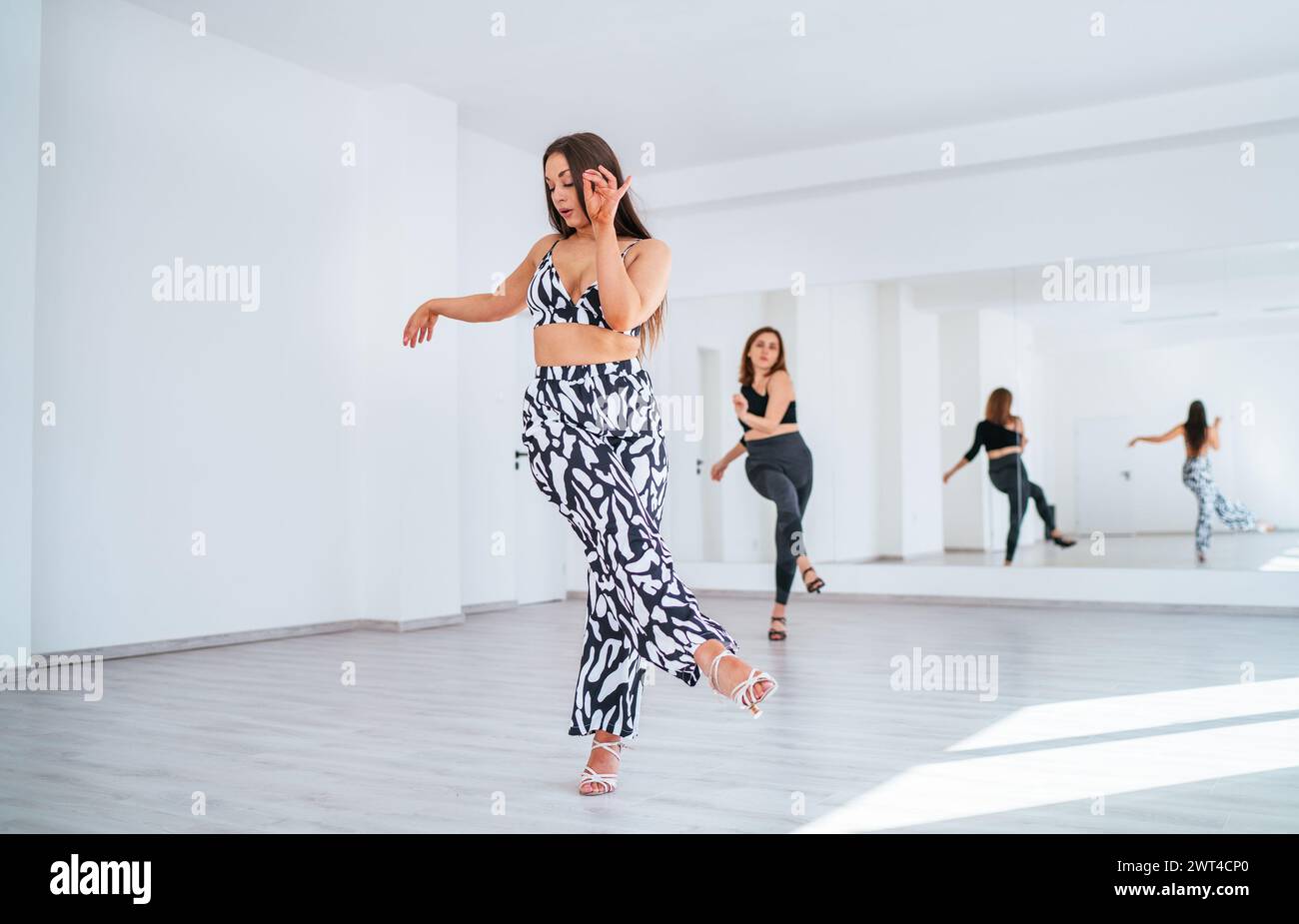 Graceful dancing women group doing elegant dance movements in white ...