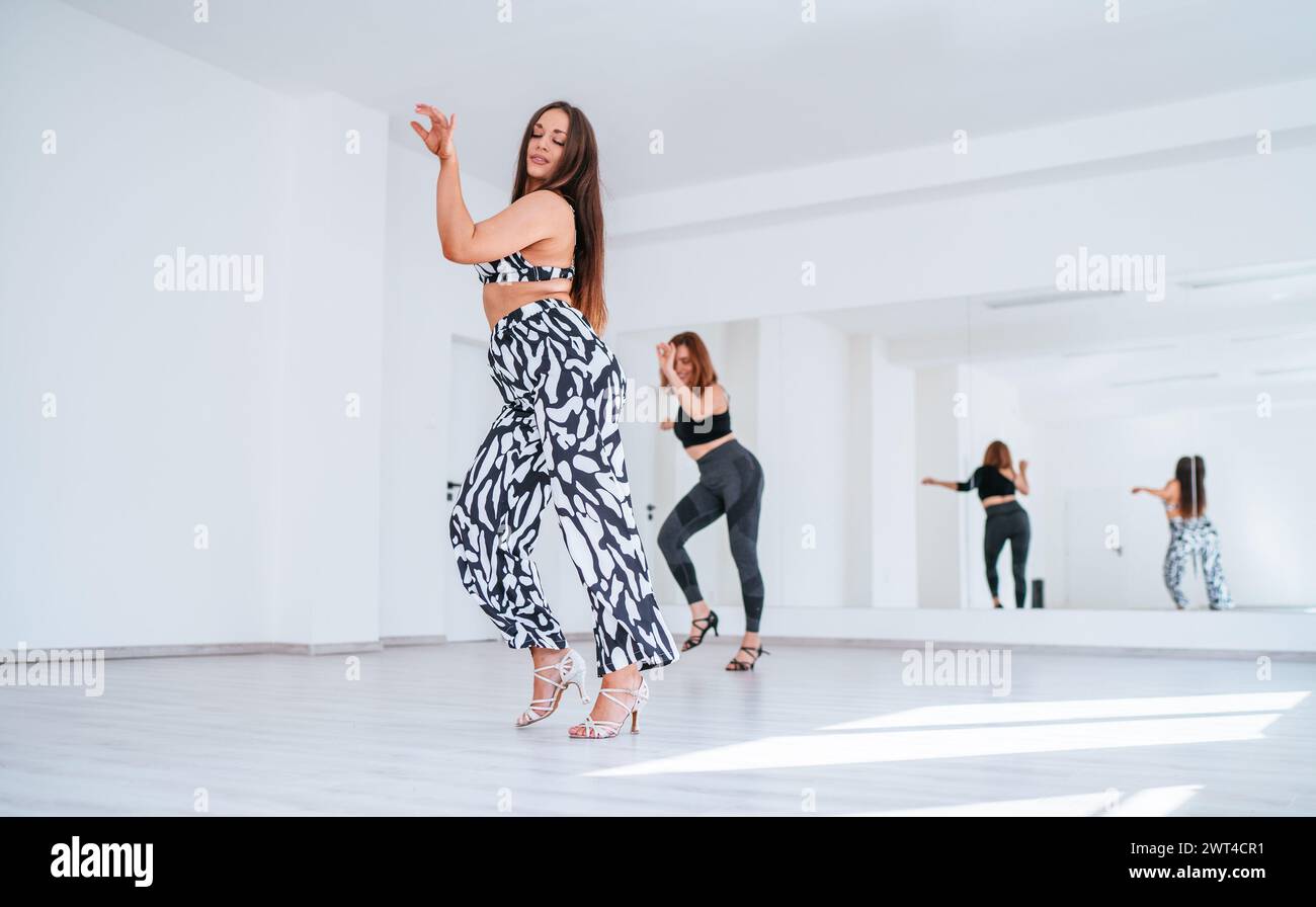 Graceful dancing women group doing elegant dance movements in white ...