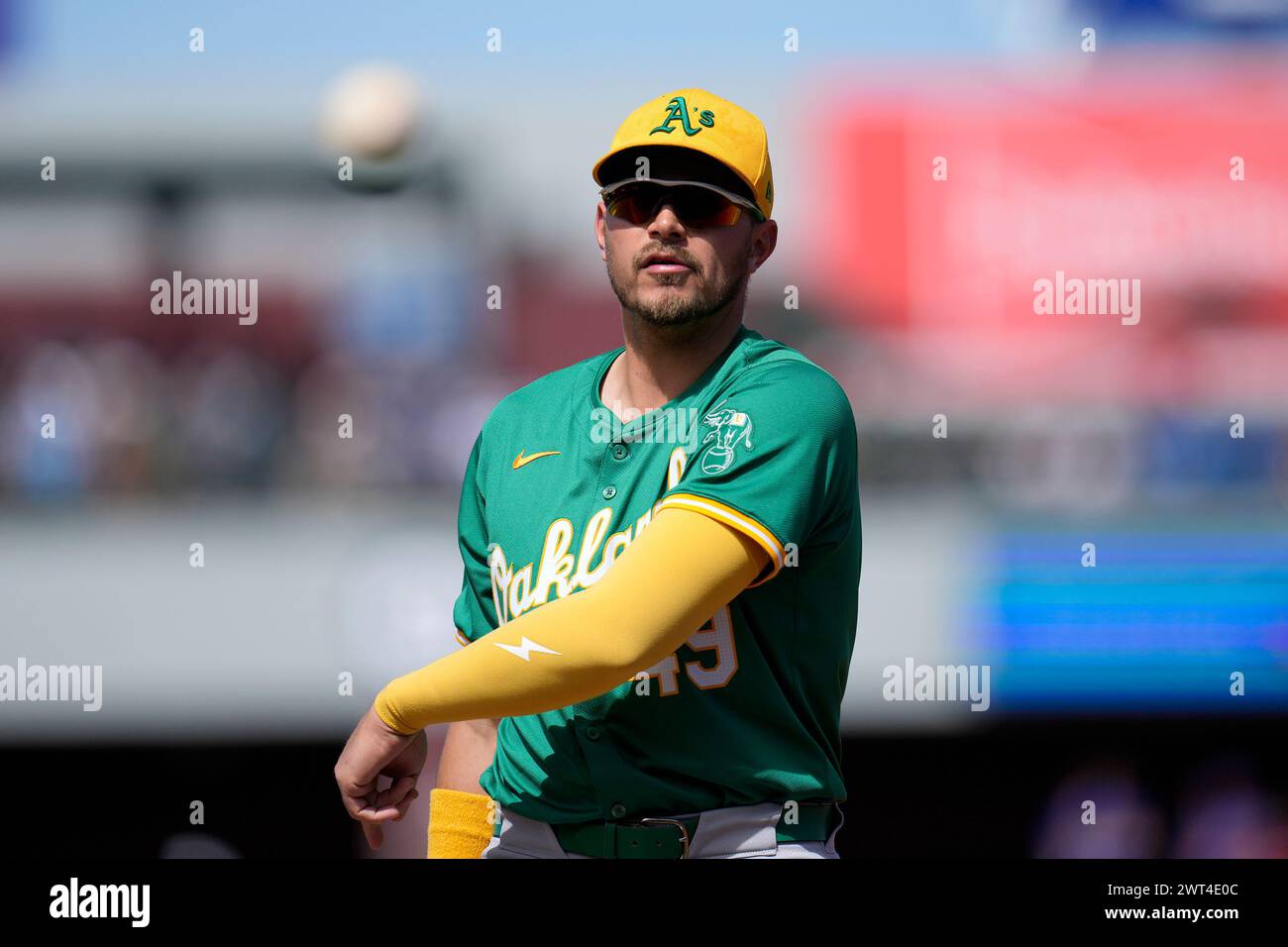 Oakland Athletics first baseman Ryan Noda throws a ball out of play ...