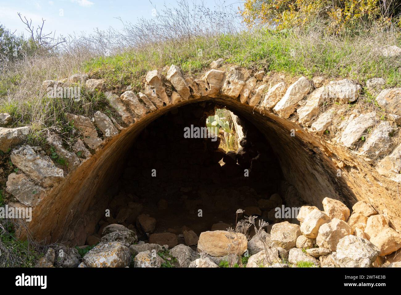 Ancient ruins of a stone structure, on a hill in a mediterranean ...