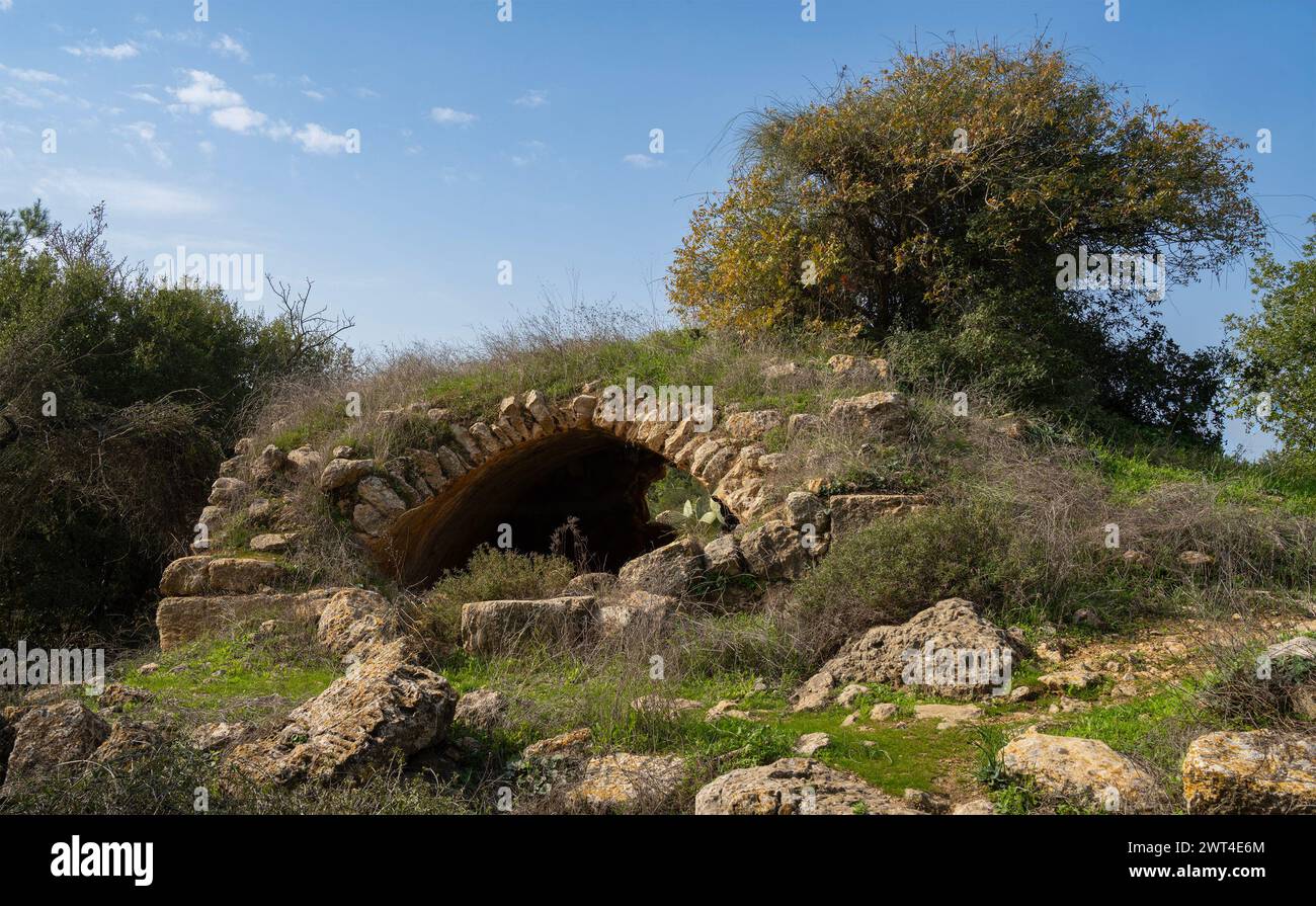 Ancient ruins of a stone structure, scattered on a hill in a ...