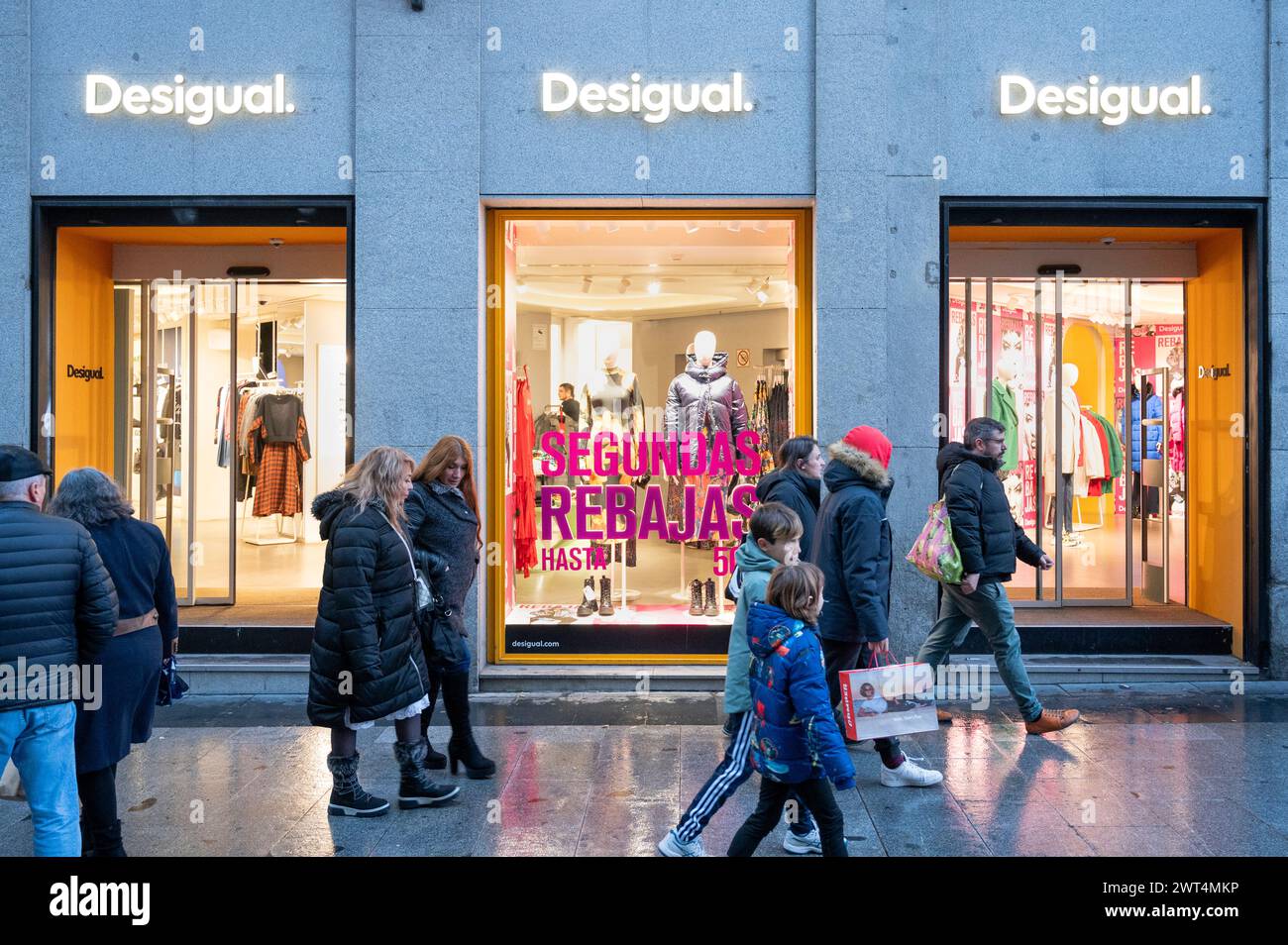 Pedestrians walk past the Spanish clothing brand Desigual store in ...