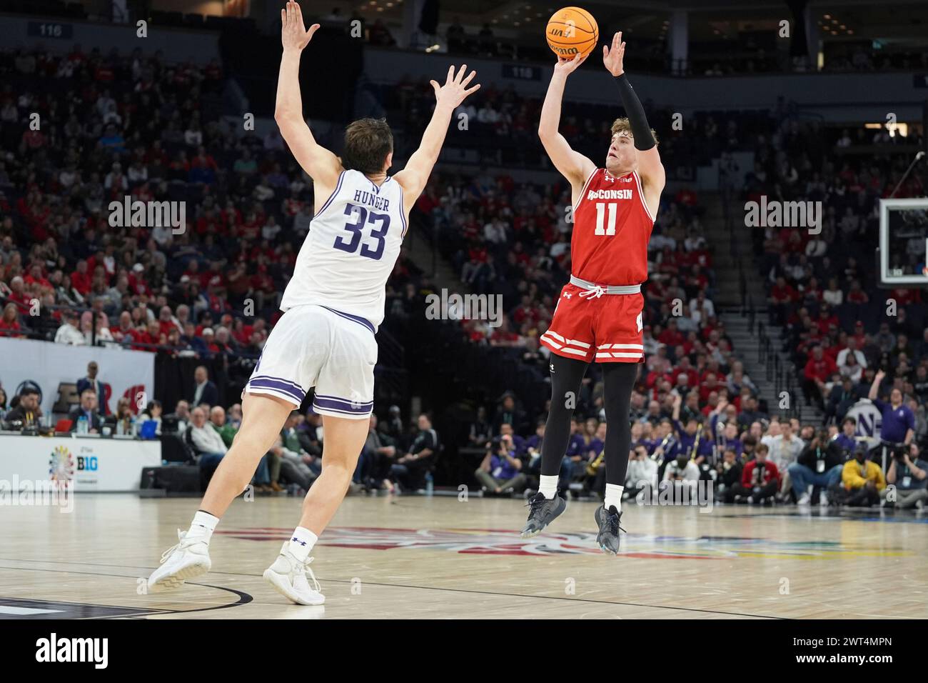 Wisconsin guard Max Klesmit (11) shoots over Northwestern forward Luke ...