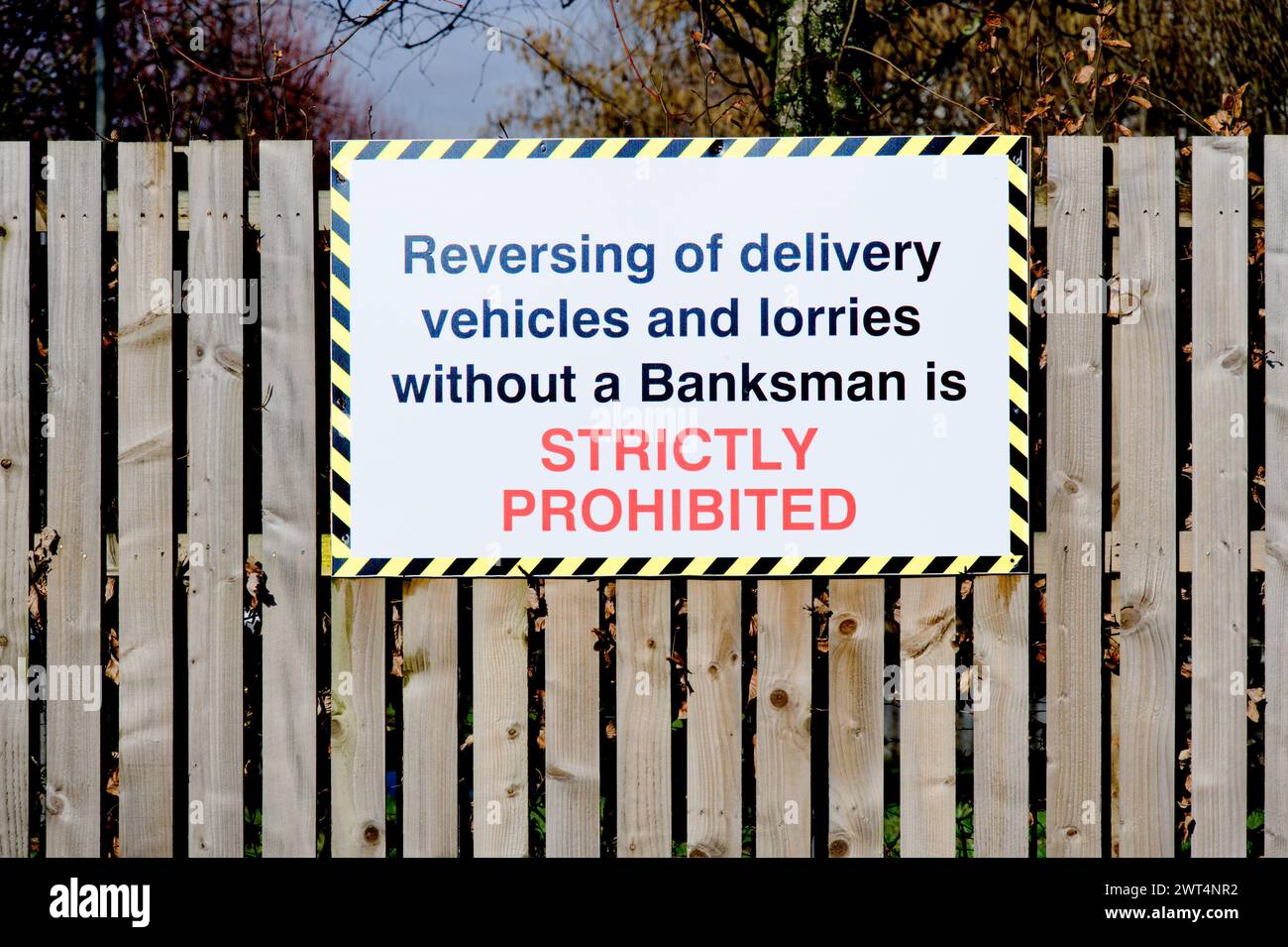 Reversing of delivery vehicles safety sign on fence at construction ...