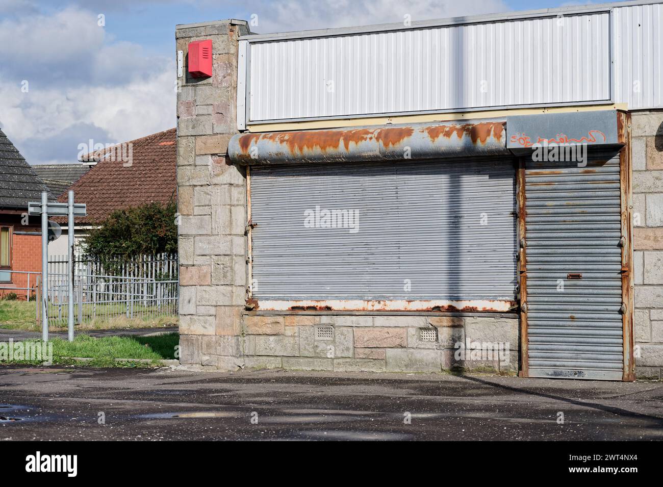 Shop window shutters closed due to business closure Stock Photo - Alamy