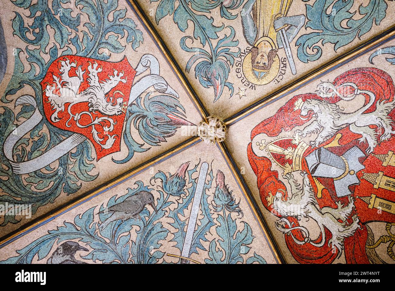 Ornate ceiling frescoes featuring medieval heraldic symbols in an ...