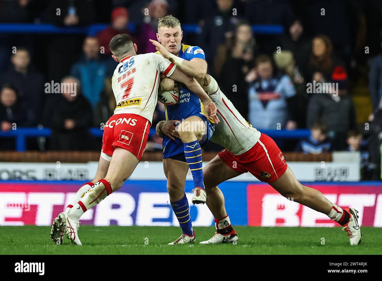 Lachlan Miller of Leeds Rhinos is tackled by Lewis Dodd of St. Helens ...