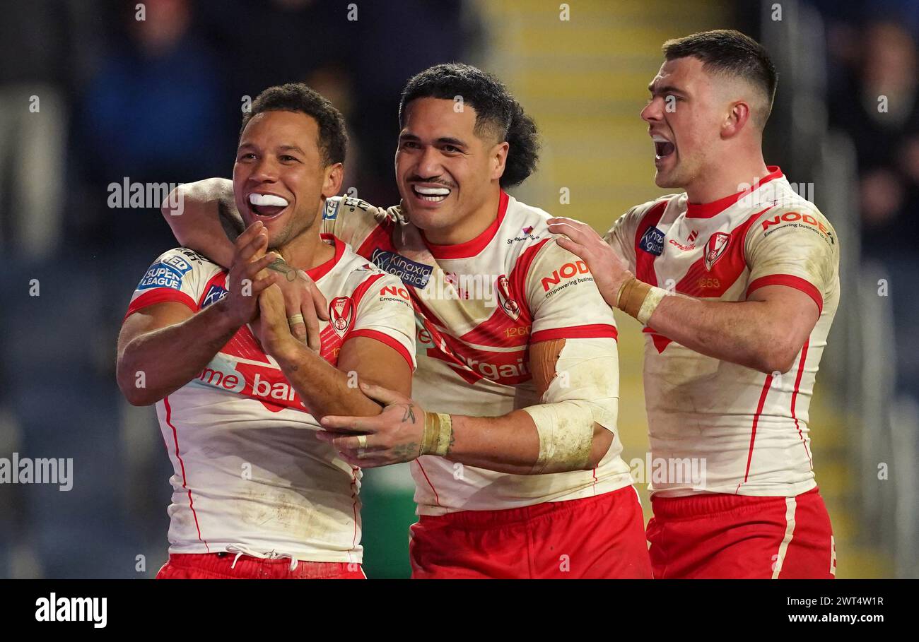 St Helens' Moses Mbye (left) celebrates scoring their third try with ...