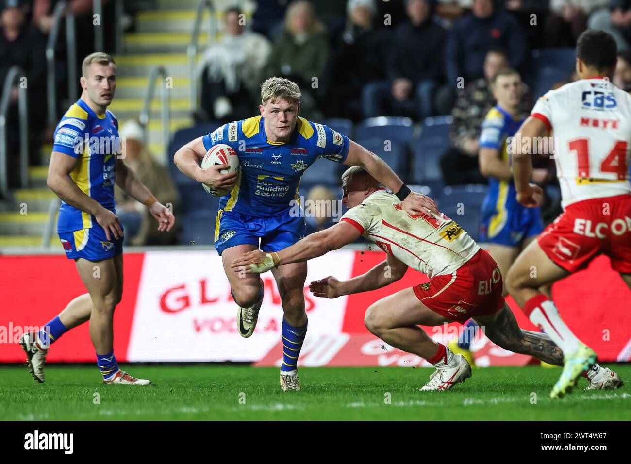 James McDonnell of Leeds Rhinos is tackled by Jake Wingfield of St ...
