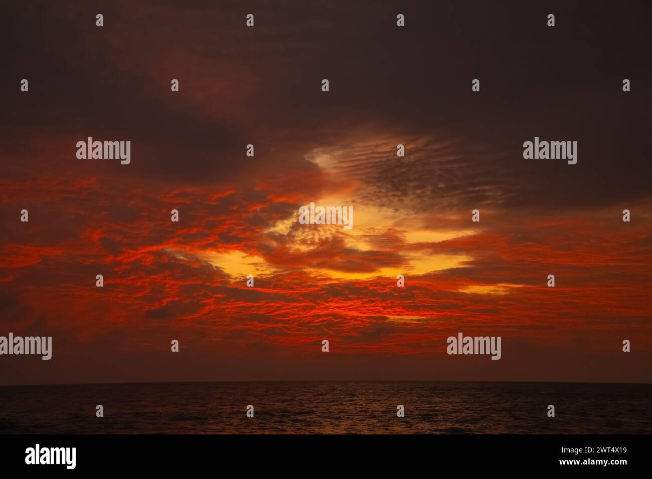 stunningly beautiful bright red dramatic sunset sky over indian ocean ...
