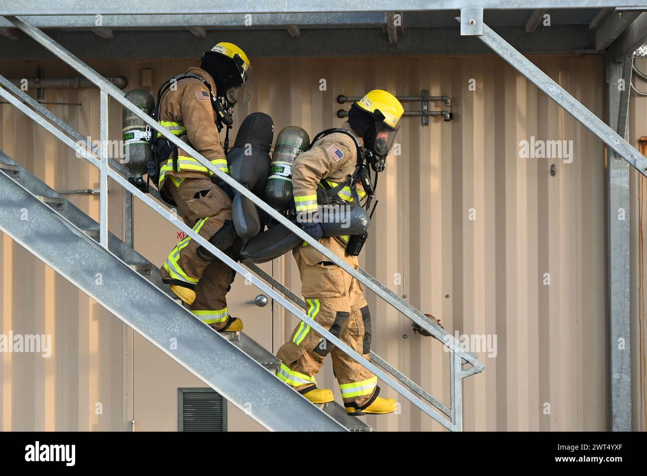 Students assigned to the 312th Training Squadron carry a training dummy ...