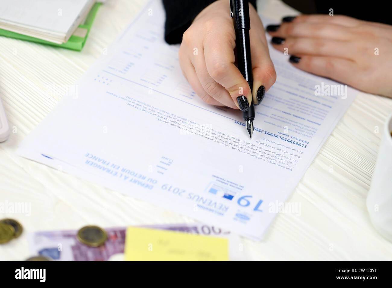 KYIV, UKRAINE - OCTOBER 31, 2023 Accountant fill french tax form 2042 ...