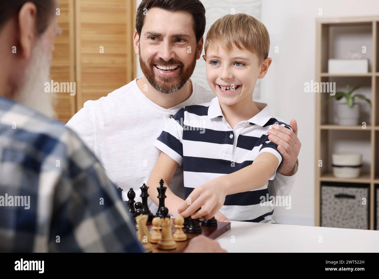 Father grandfather son playing chess hi-res stock photography and ...