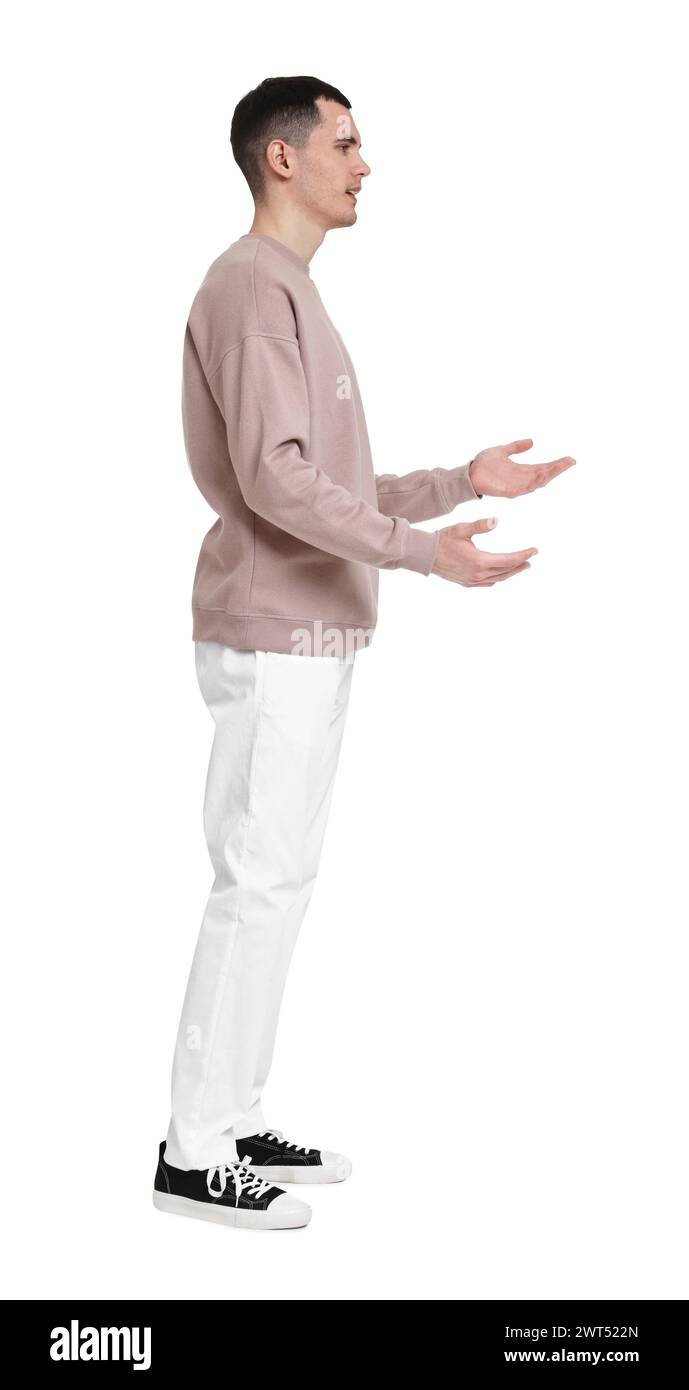 Handsome young man greeting someone on white background Stock Photo - Alamy