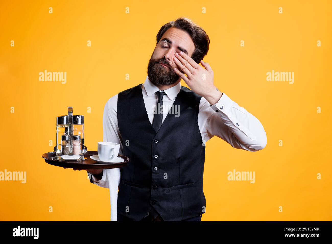 Overworked butler stretching in studio, feeling exhausted after long ...