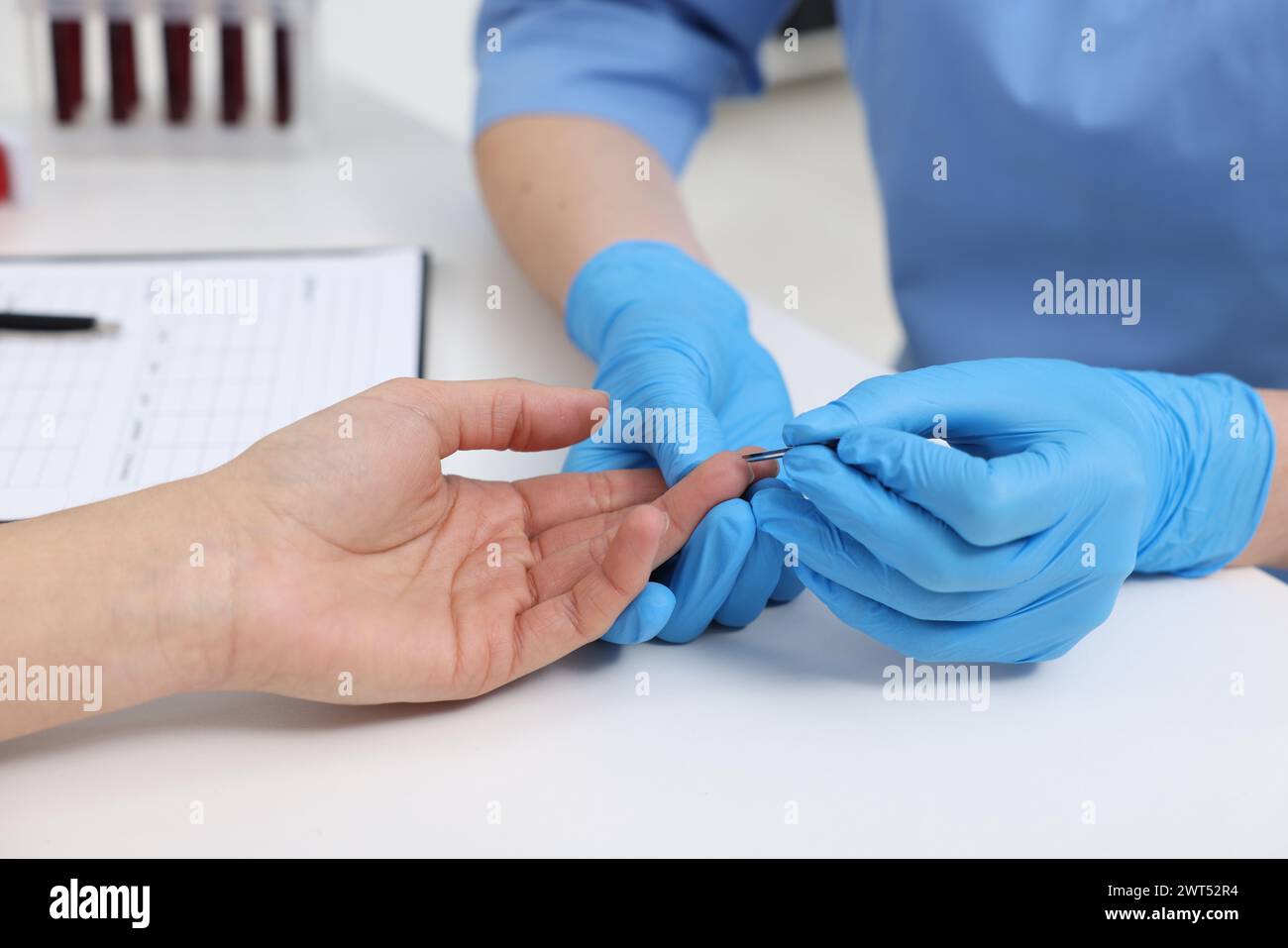 Laboratory testing. Doctor taking blood sample from patient at white ...