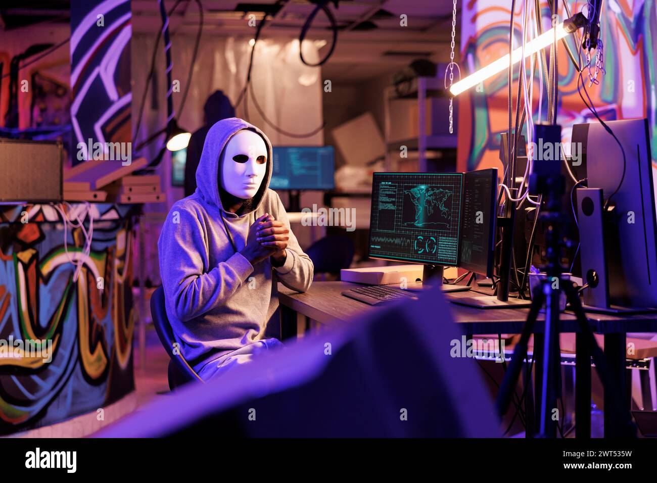 Anonymous hacker filming scam video on mobile phone while doing ...