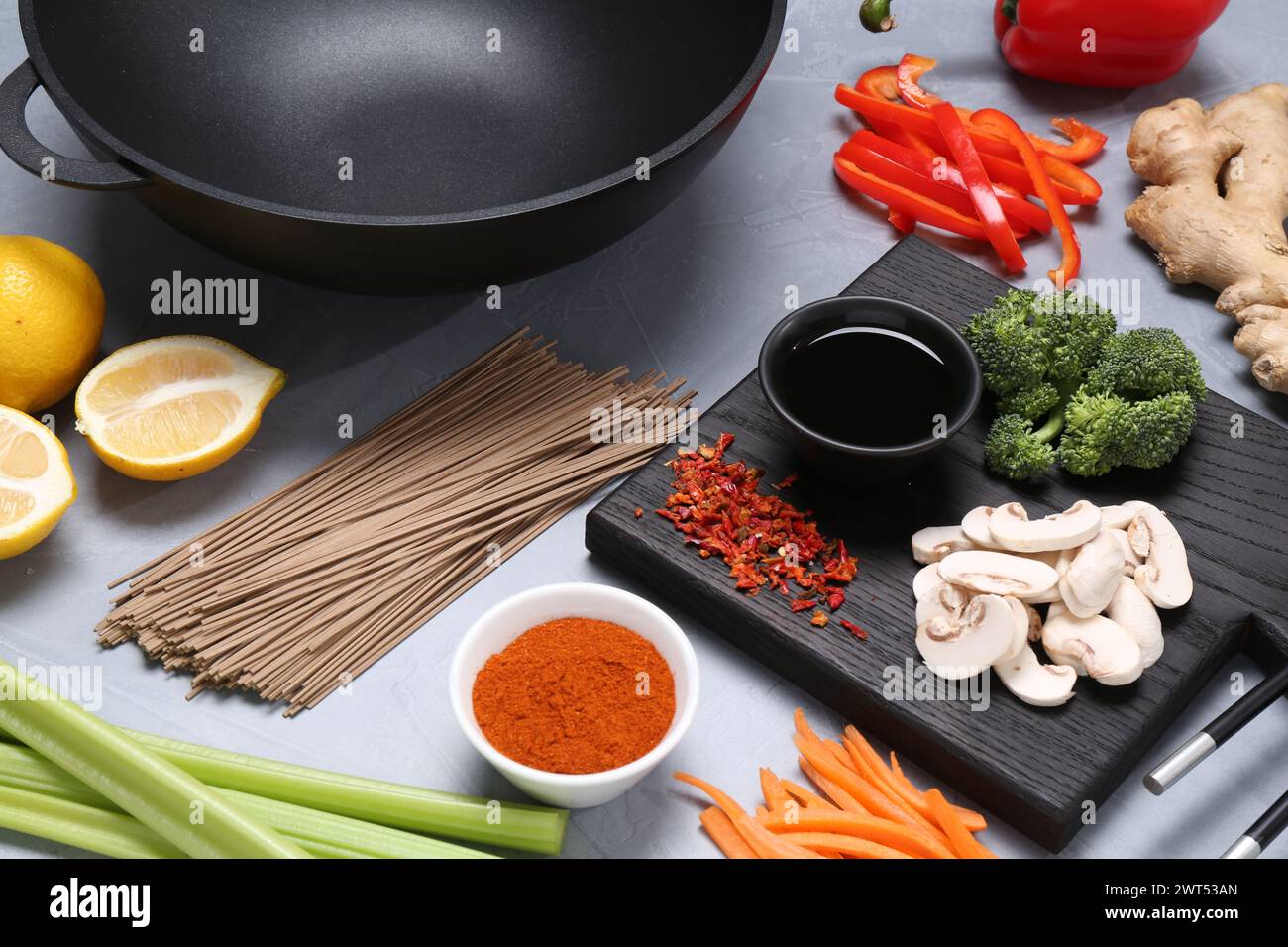 Wok and different products on grey table, closeup Stock Photo - Alamy