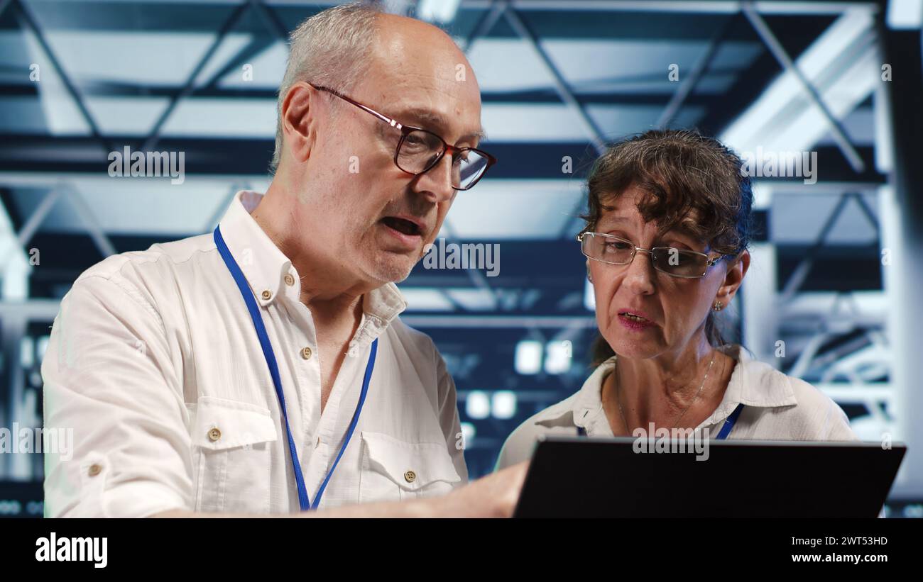 It Programmers In Data Center Using Laptop To Monitor Energy Efficient Rackmounts Server