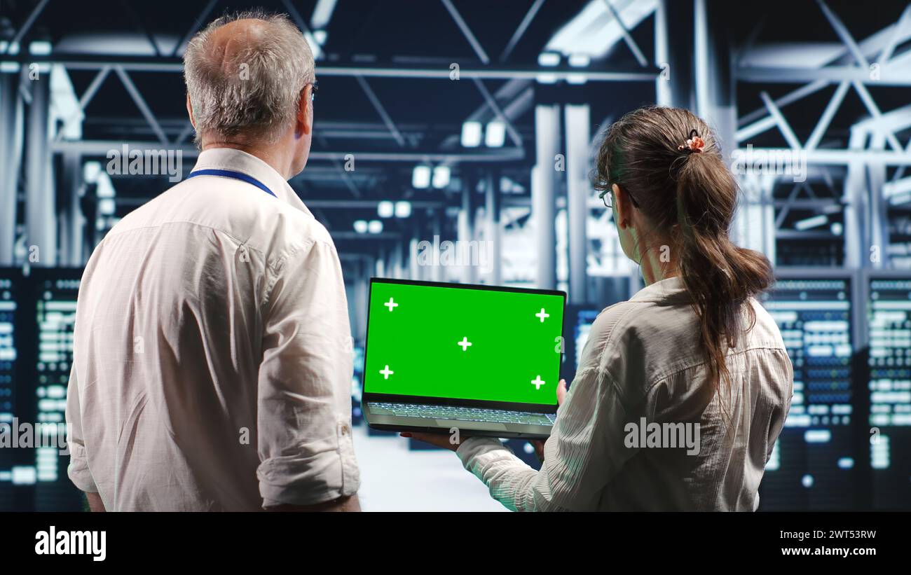 Coworkers in server room expertly managing data while navigating ... Coworkers in server room expertly managing data while navigating ...