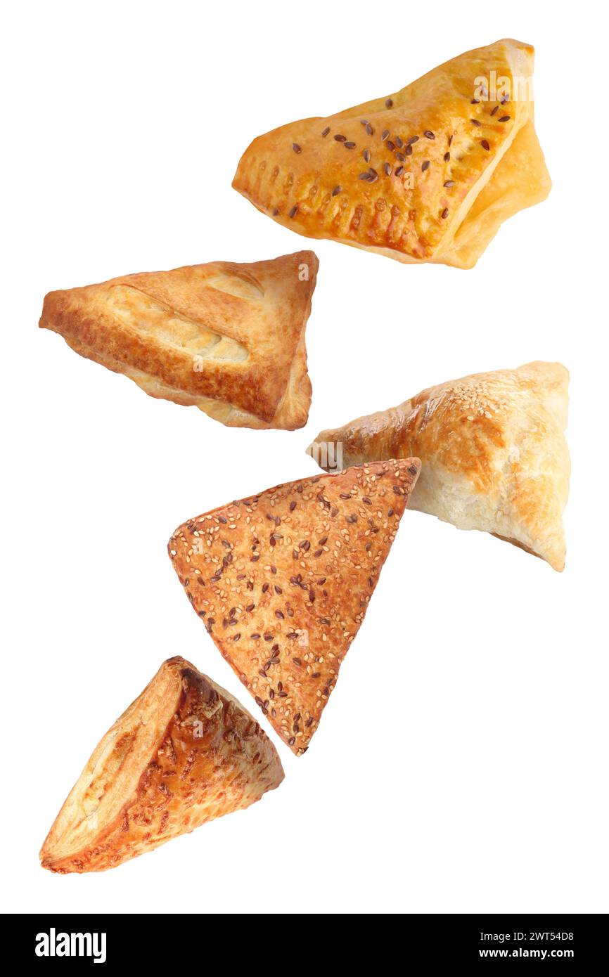 Different tasty puff pastries falling on white background Stock Photo ...