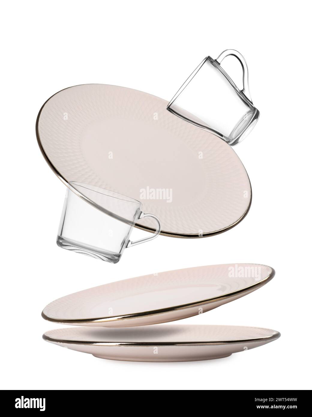 Clean plates and cups falling on white background Stock Photo - Alamy