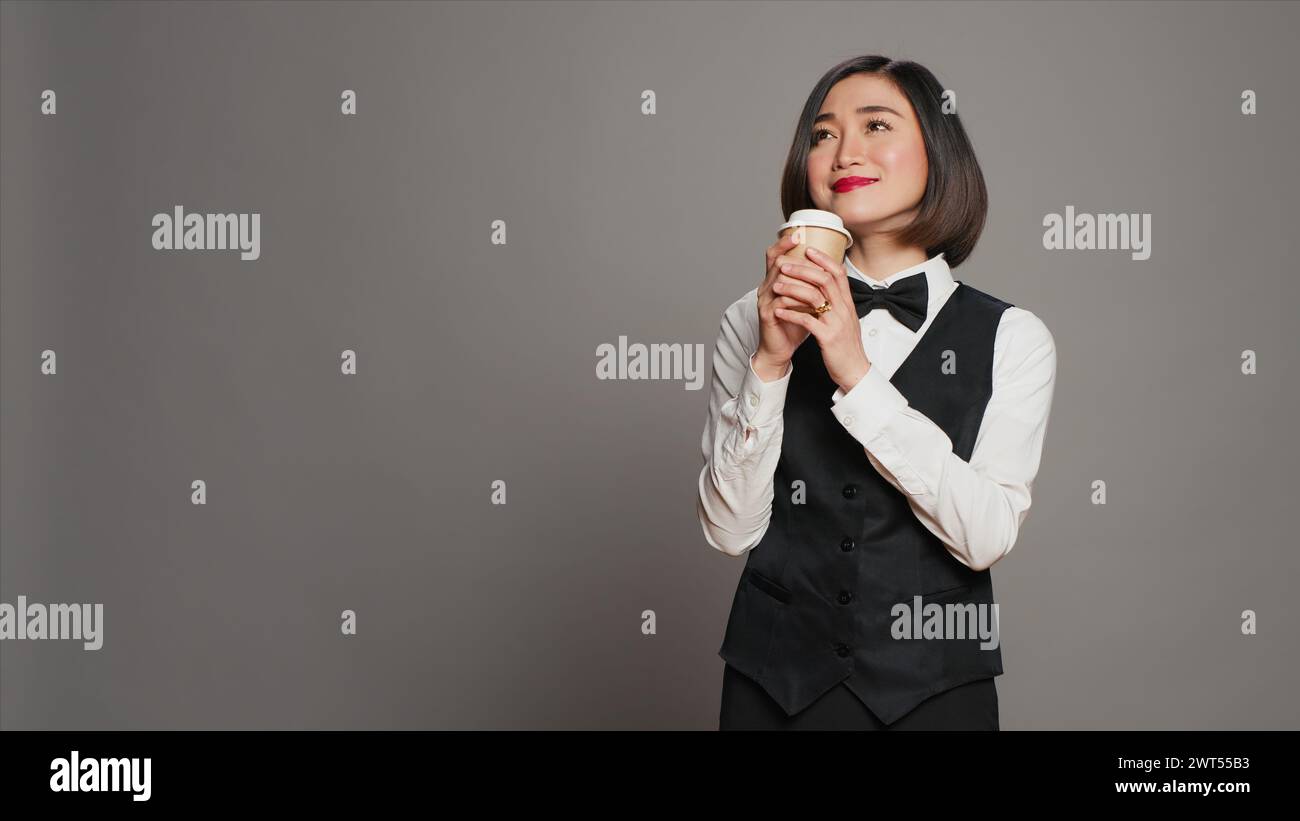 Confident young hotel receptionist standing hi-res stock photography ...