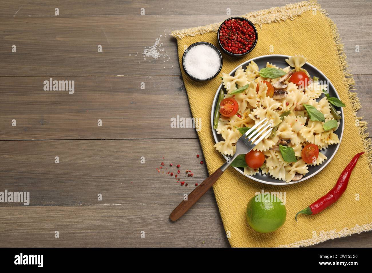 Vegetarian pasta with mushrooms, basil, string beans and tomatoes on ...