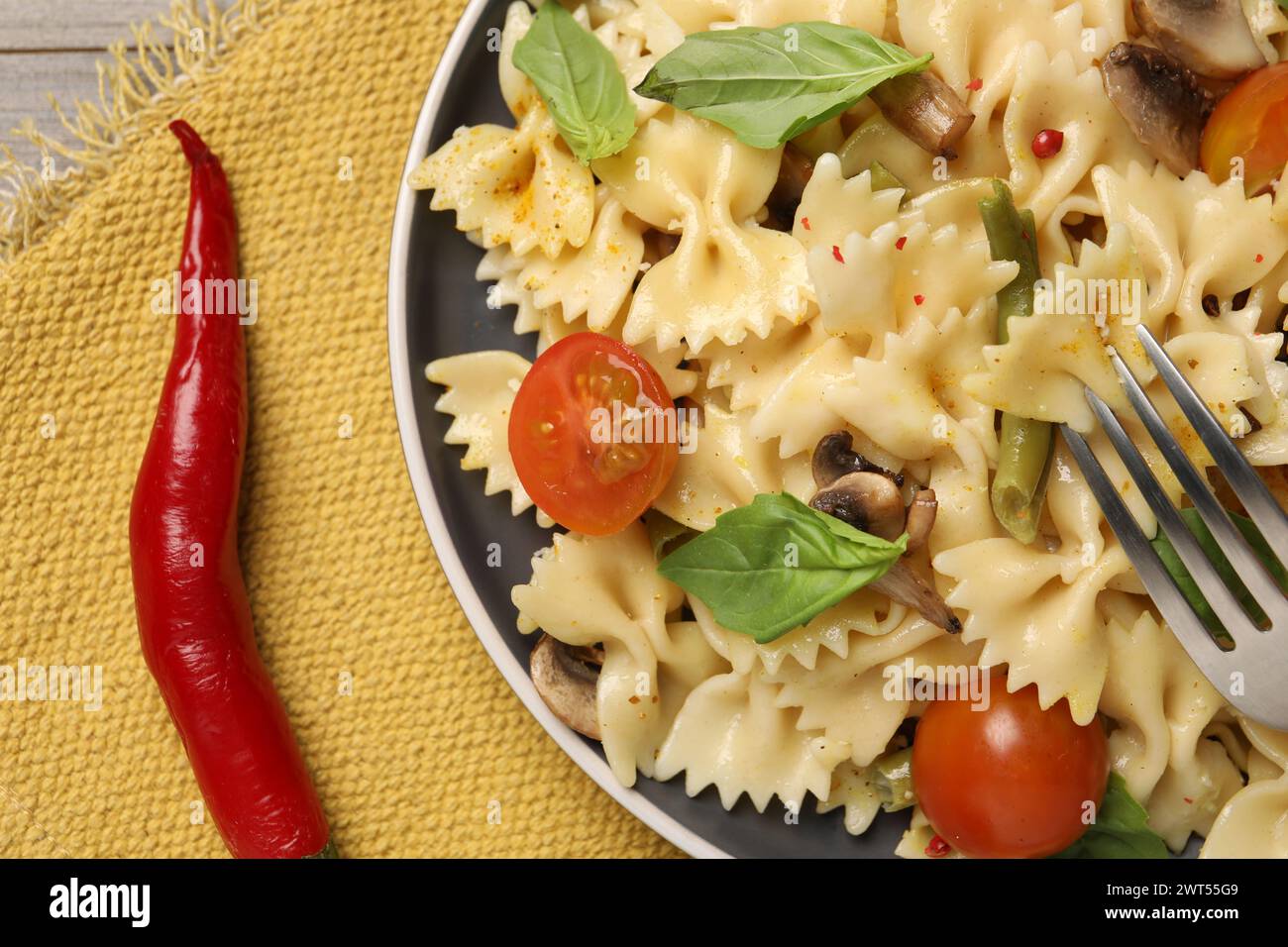 Vegetarian pasta with mushrooms, basil, string beans and tomatoes on ...