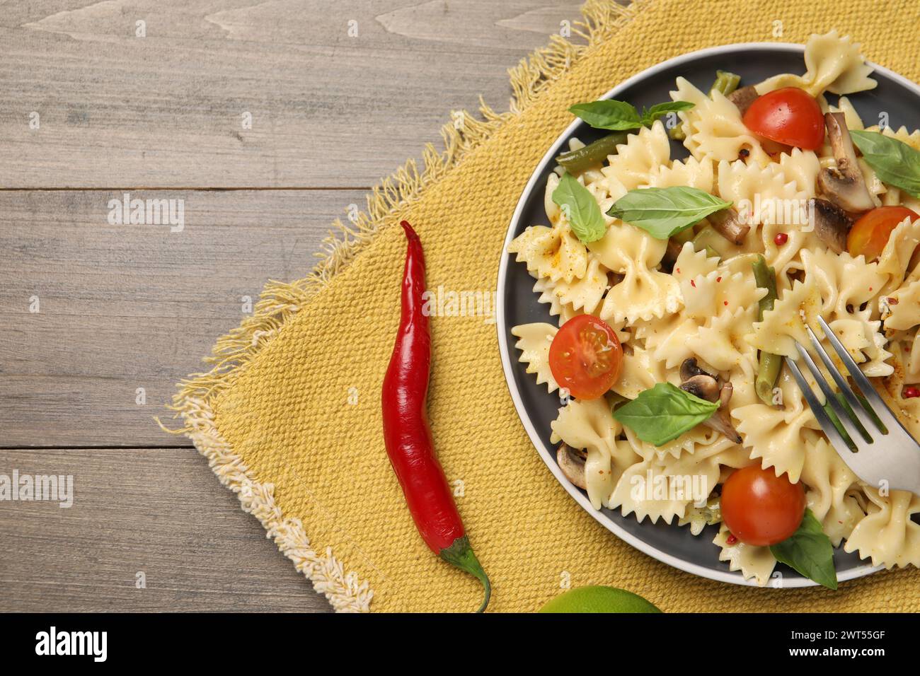 Vegetarian pasta with mushrooms, basil, string beans and tomatoes on ...