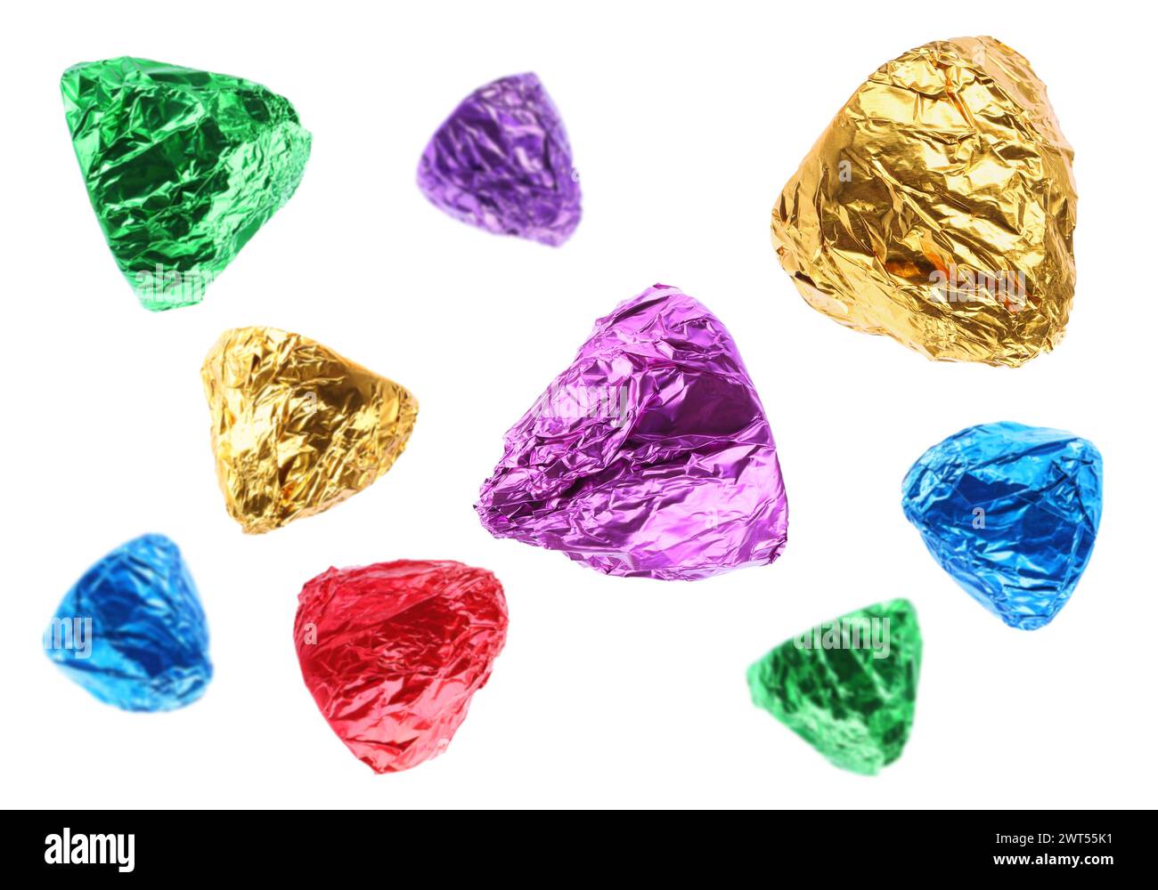 Tasty candies in bright wrappers falling on white background Stock ...
