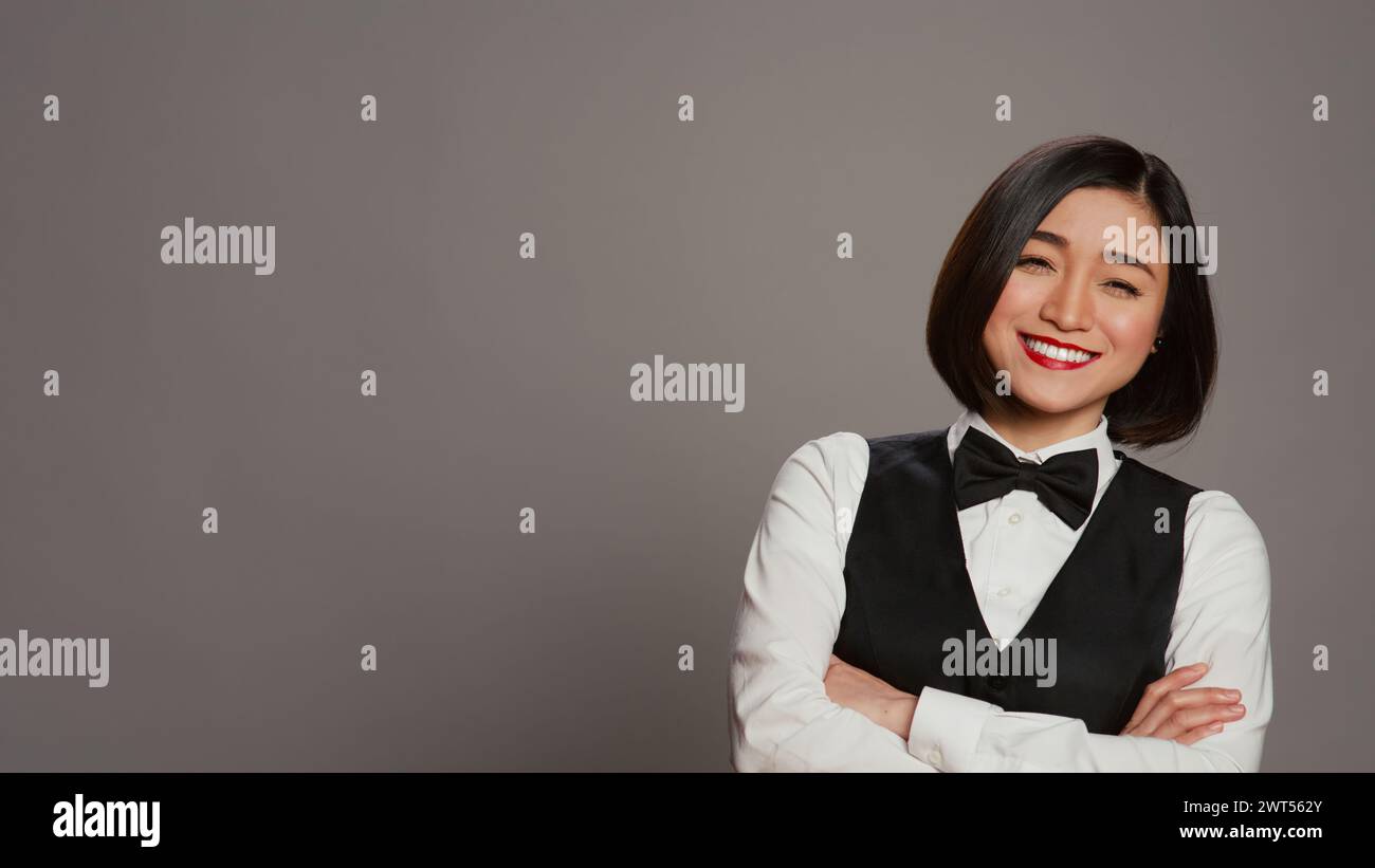 Asian woman hotel concierge wearing elegant uniform with bow, working ...