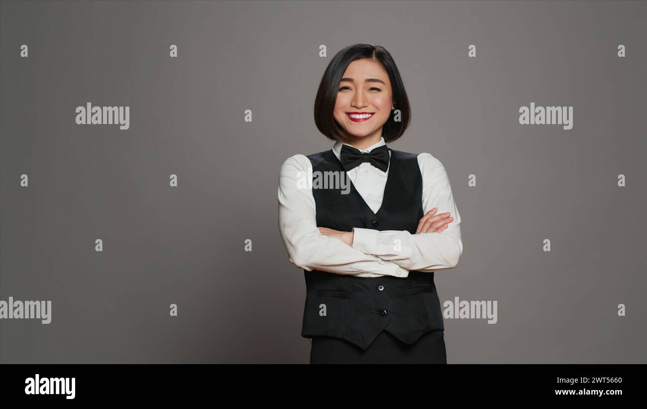 Asian woman hotel concierge wearing elegant uniform with bow, working ...