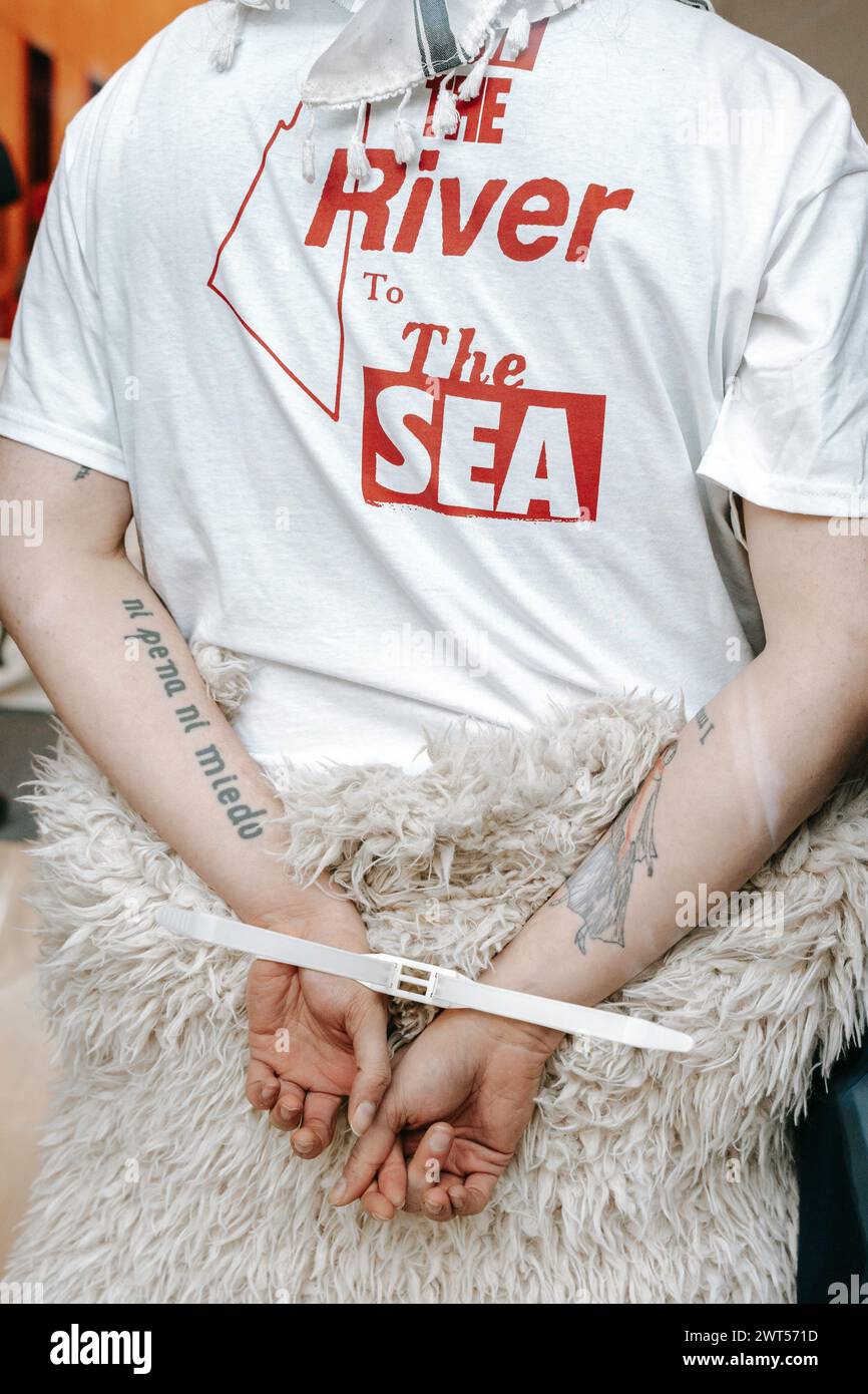 New York, USA. 14th Mar, 2024. Protester wearing a t-shirt with a ...